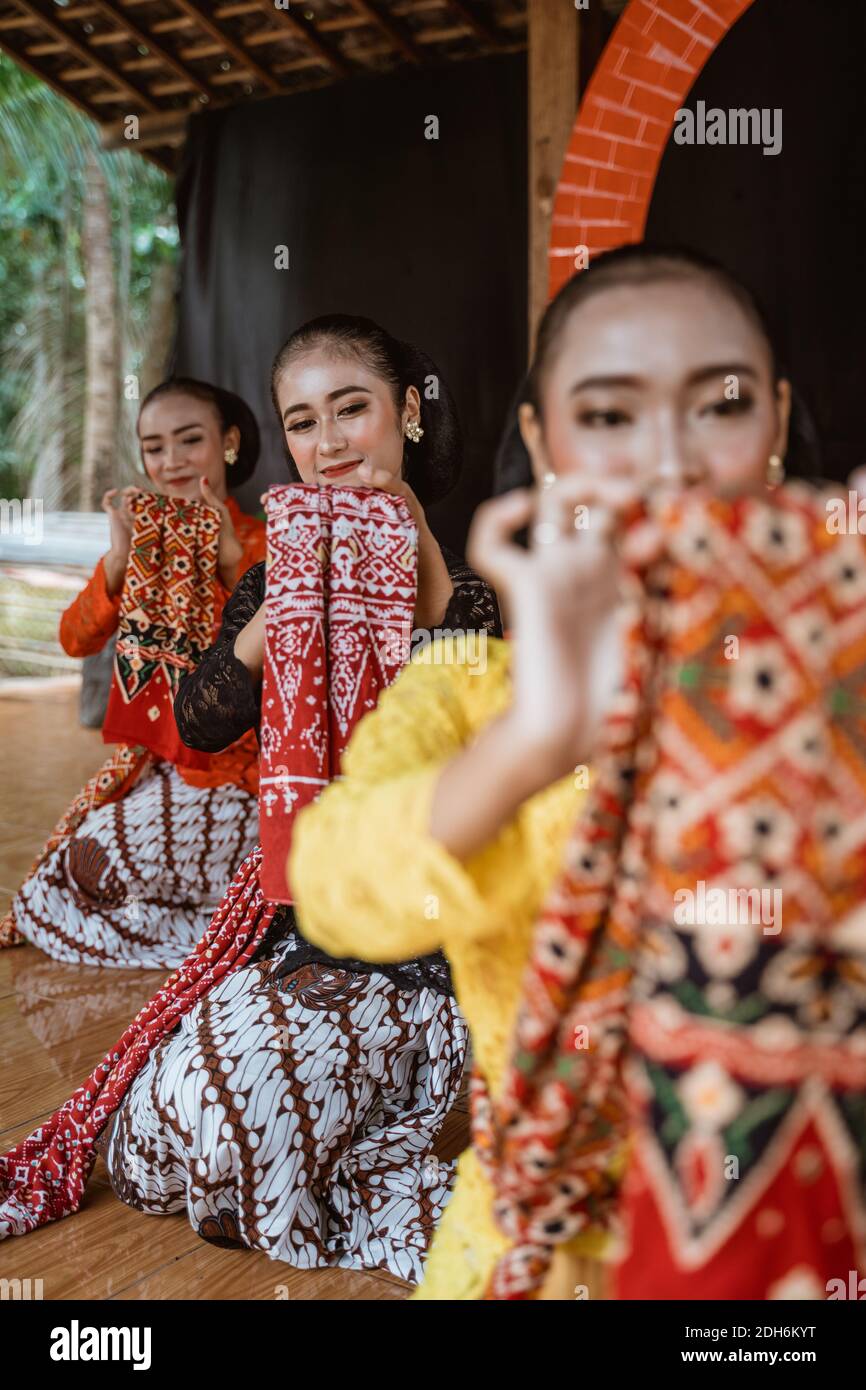 portrait of three young women presenting traditional Javanese dance ...