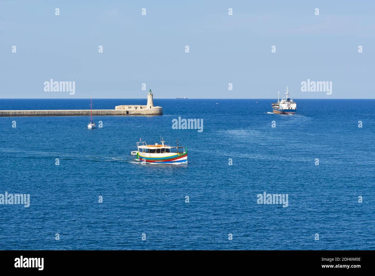Cargo ship and pleasure craft Stock Photo - Alamy