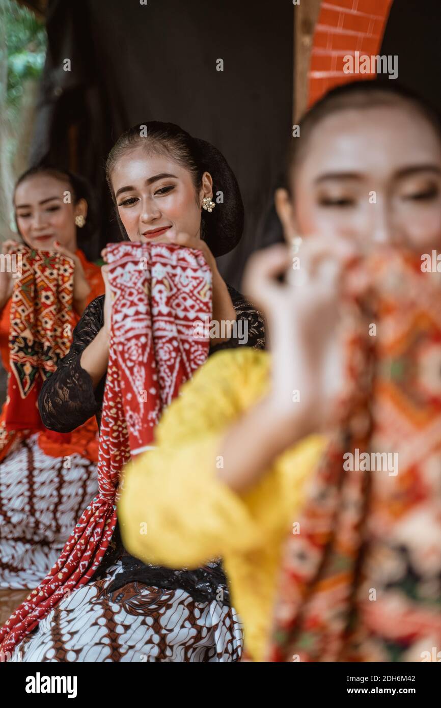 portrait of three young women presenting traditional Javanese dance ...