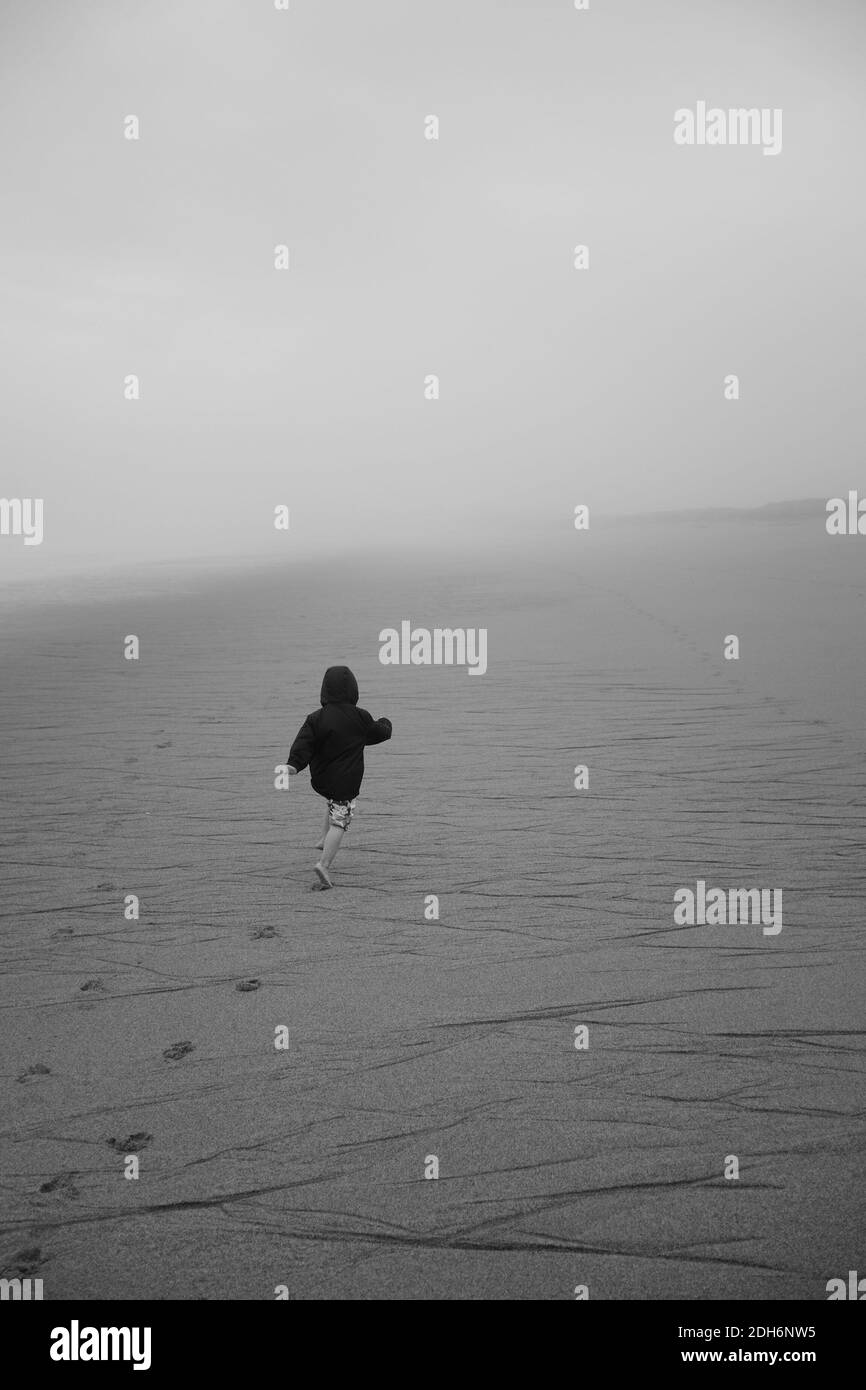Boy running in rain hi-res stock photography and images - Alamy