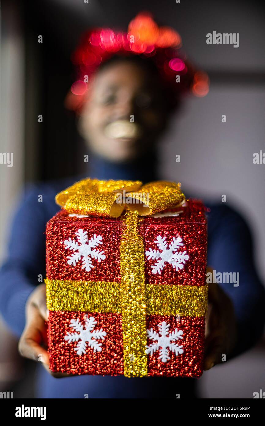 Happy african man giving a christmas gift box Stock Photo - Alamy