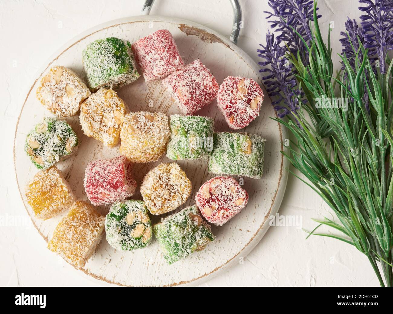 Sweet Turkish delight in coconut white shavings, dessert lies in rows ...