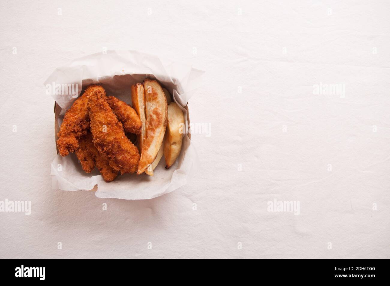 breaded chicken fingers and fries in a take out container Stock Photo ...