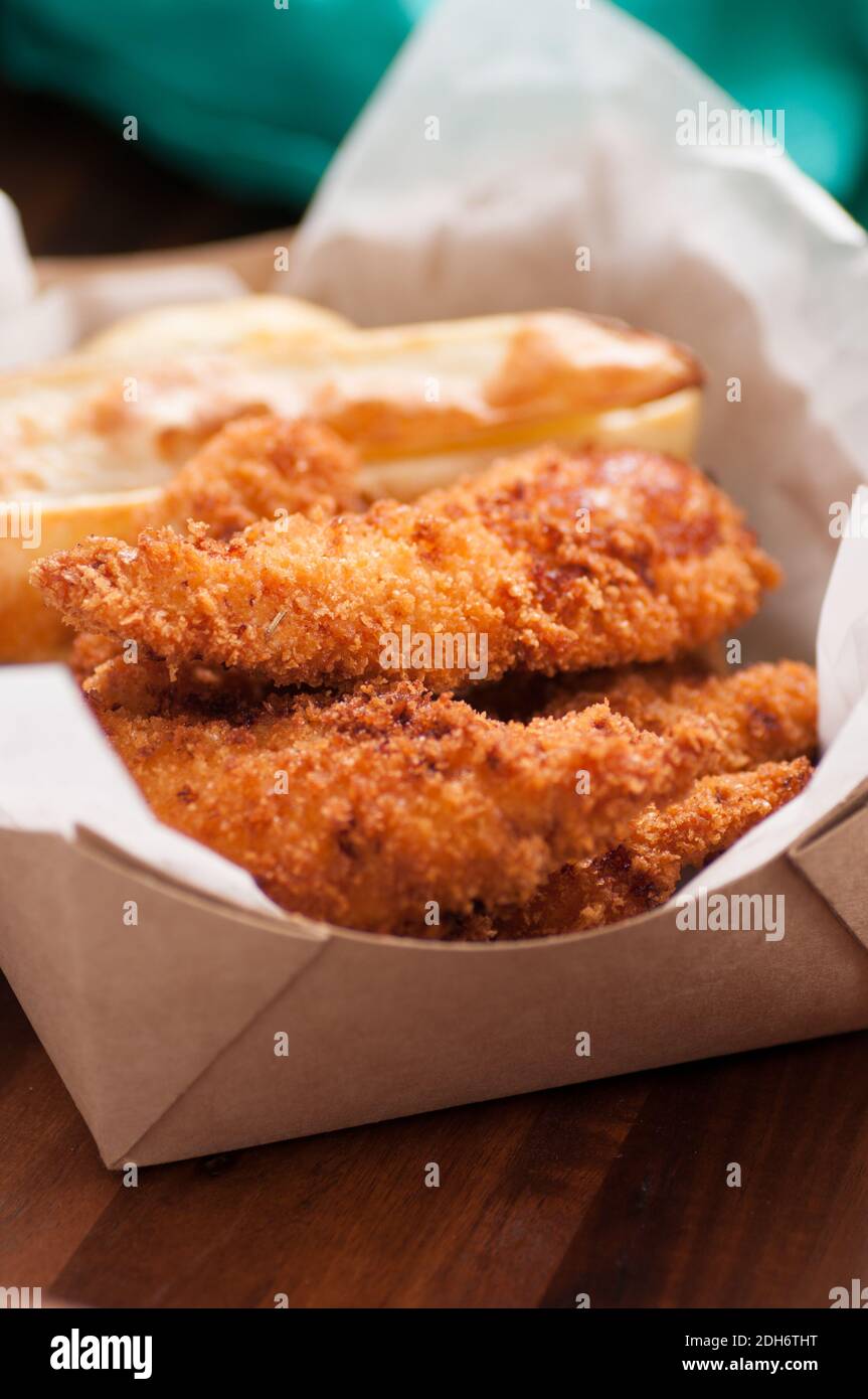 breaded chicken fingers and fries in a take out container Stock Photo ...