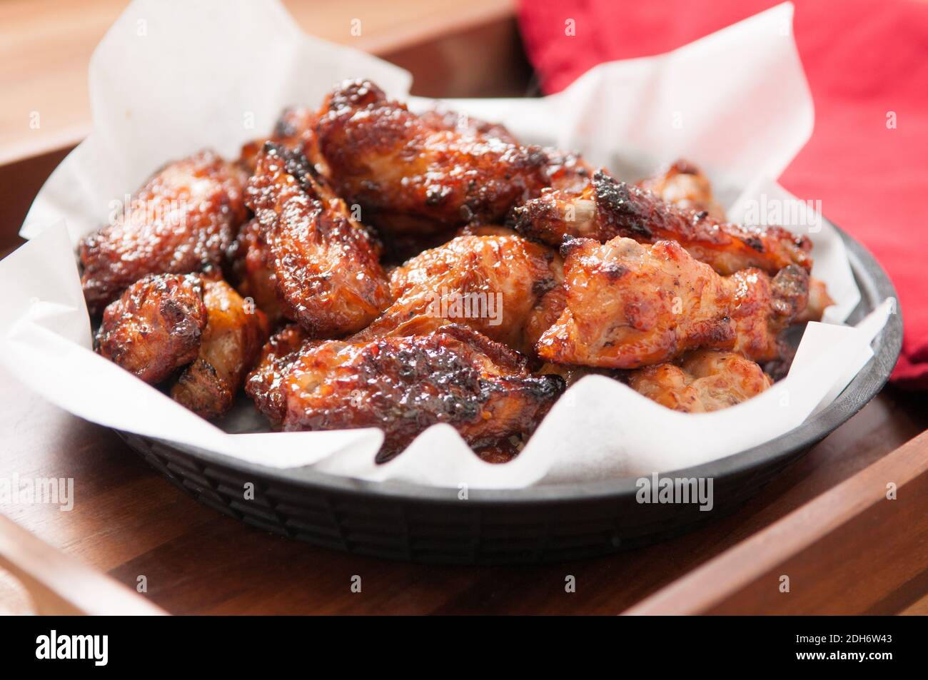 hot and spicy buffalo style chicken wings in a basket Stock Photo - Alamy