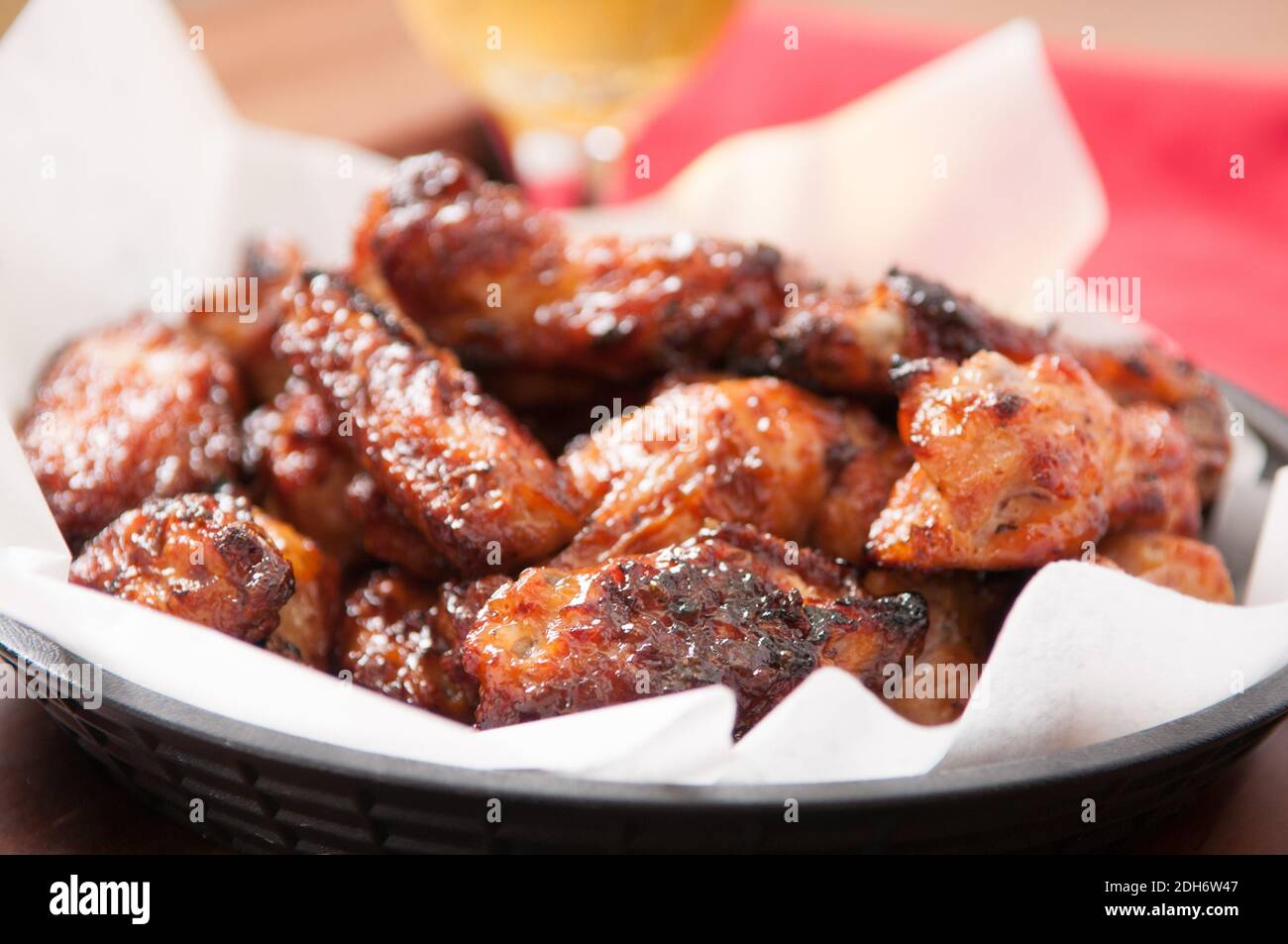 hot and spicy buffalo style chicken wings in a basket Stock Photo - Alamy