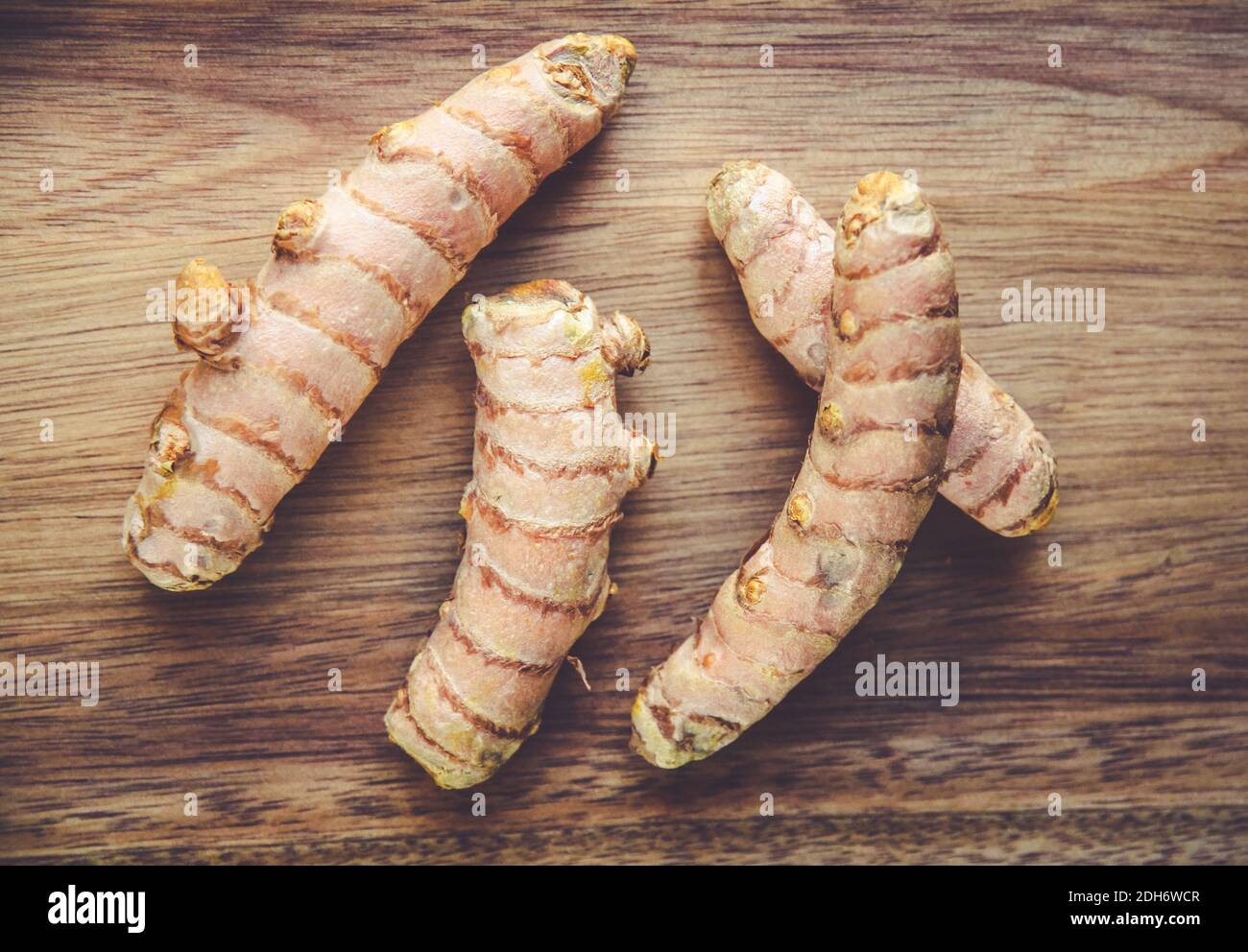 Turmeric root on a cutting board Stock Photo - Alamy