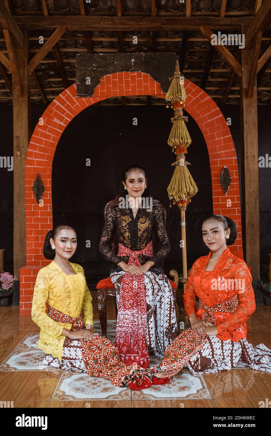 a group portrait of young woman wearing Javanese kebaya traditional ...