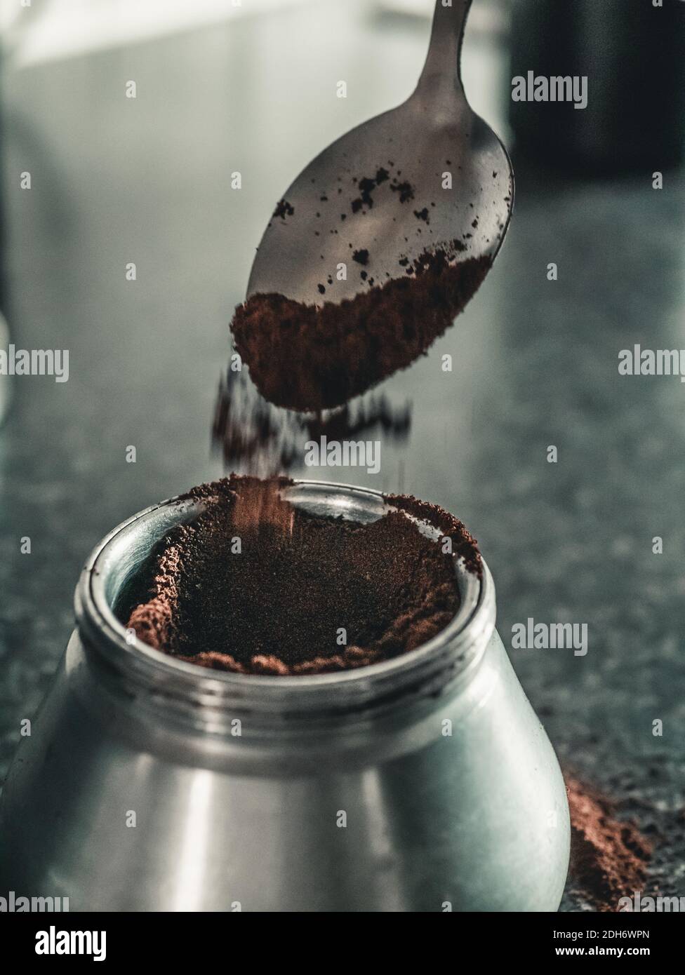 A vertical shot of the process of making and filling coffee in a mocha ...