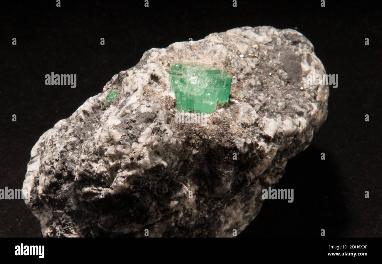rough unrefined green gemstone emeralds samples in quartz Stock Photo ...