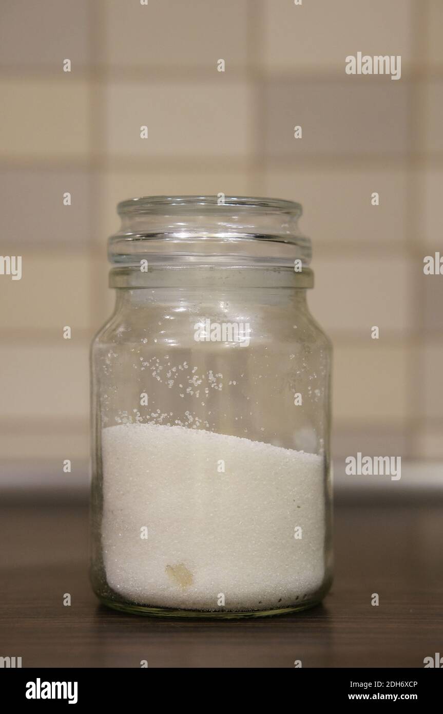 A vertical shot of a jar with sugar on the kitchen counter Stock Photo ...