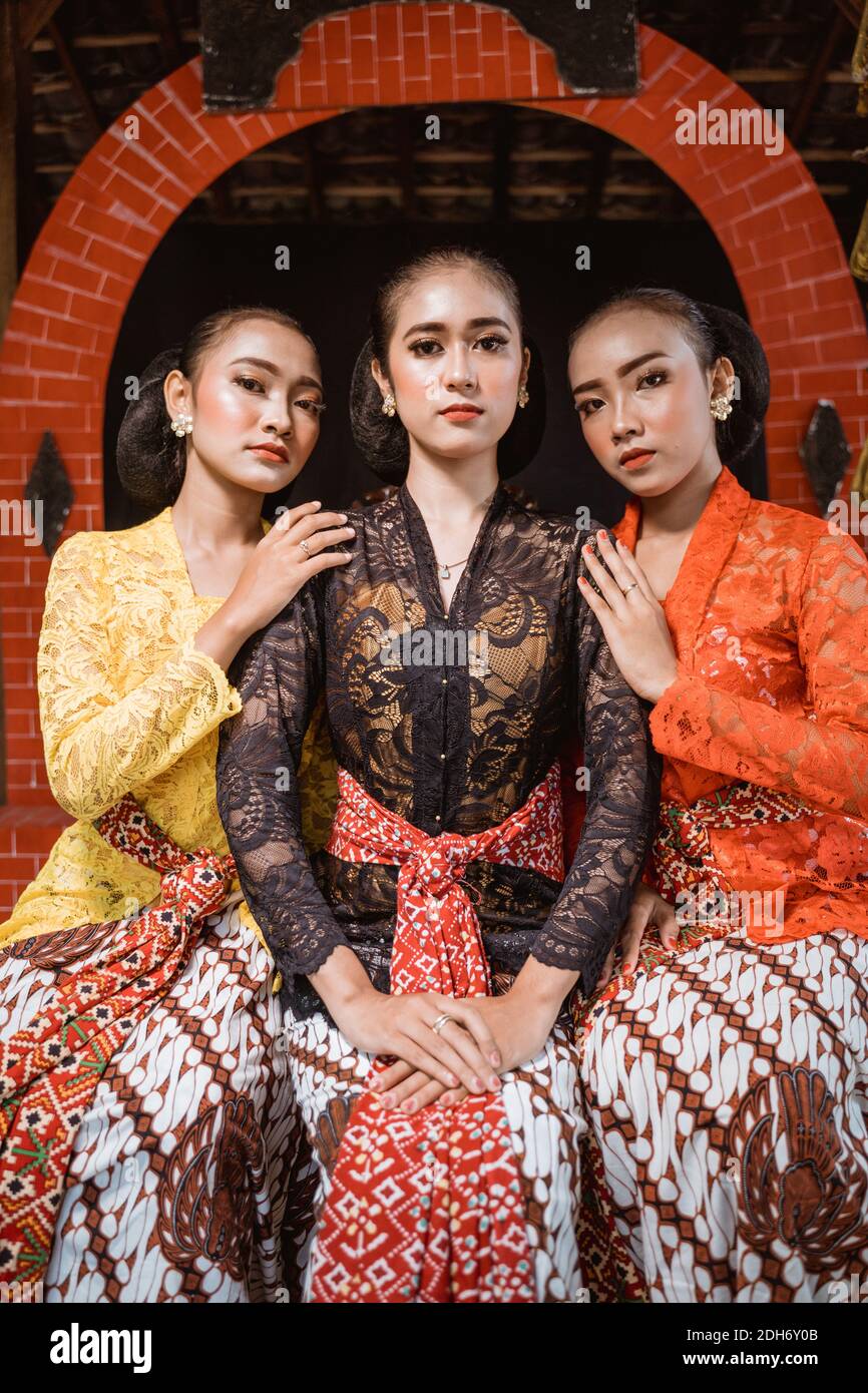 a group portrait of young woman wearing Javanese kebaya traditional ...