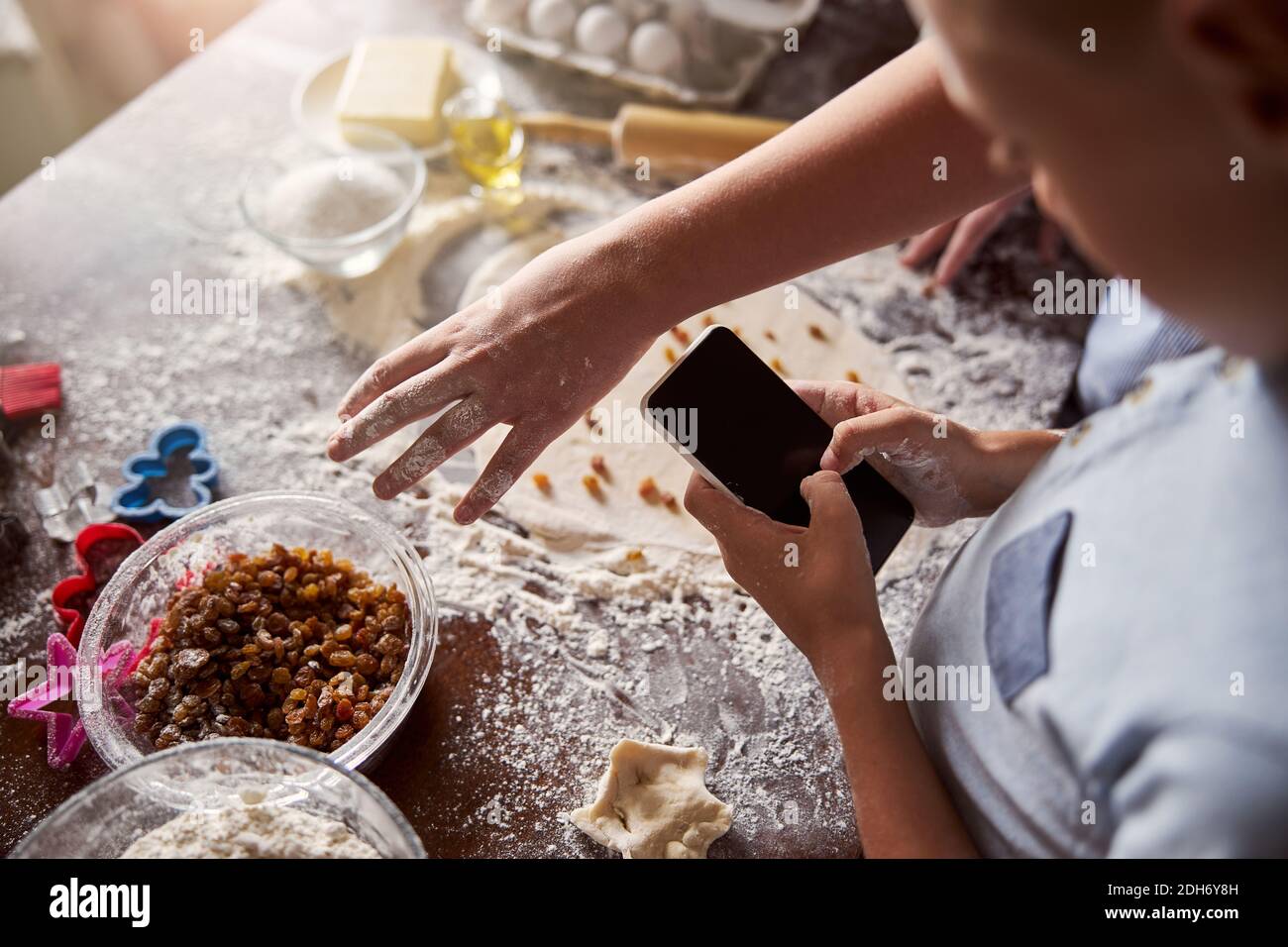 Helper of chef getting distracted and checking phone updates Stock ...