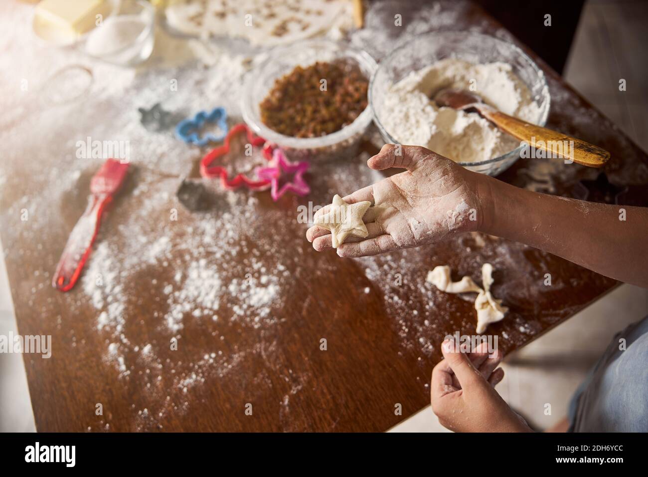 Little chef showing a star-shaped future cookie Stock Photo - Alamy