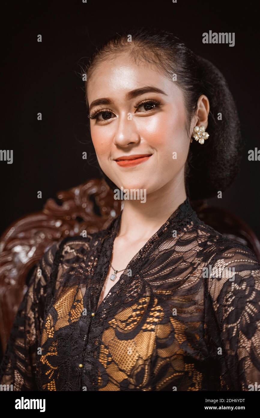 portrait of a young woman wearing Javanese kebaya traditional clothes ...