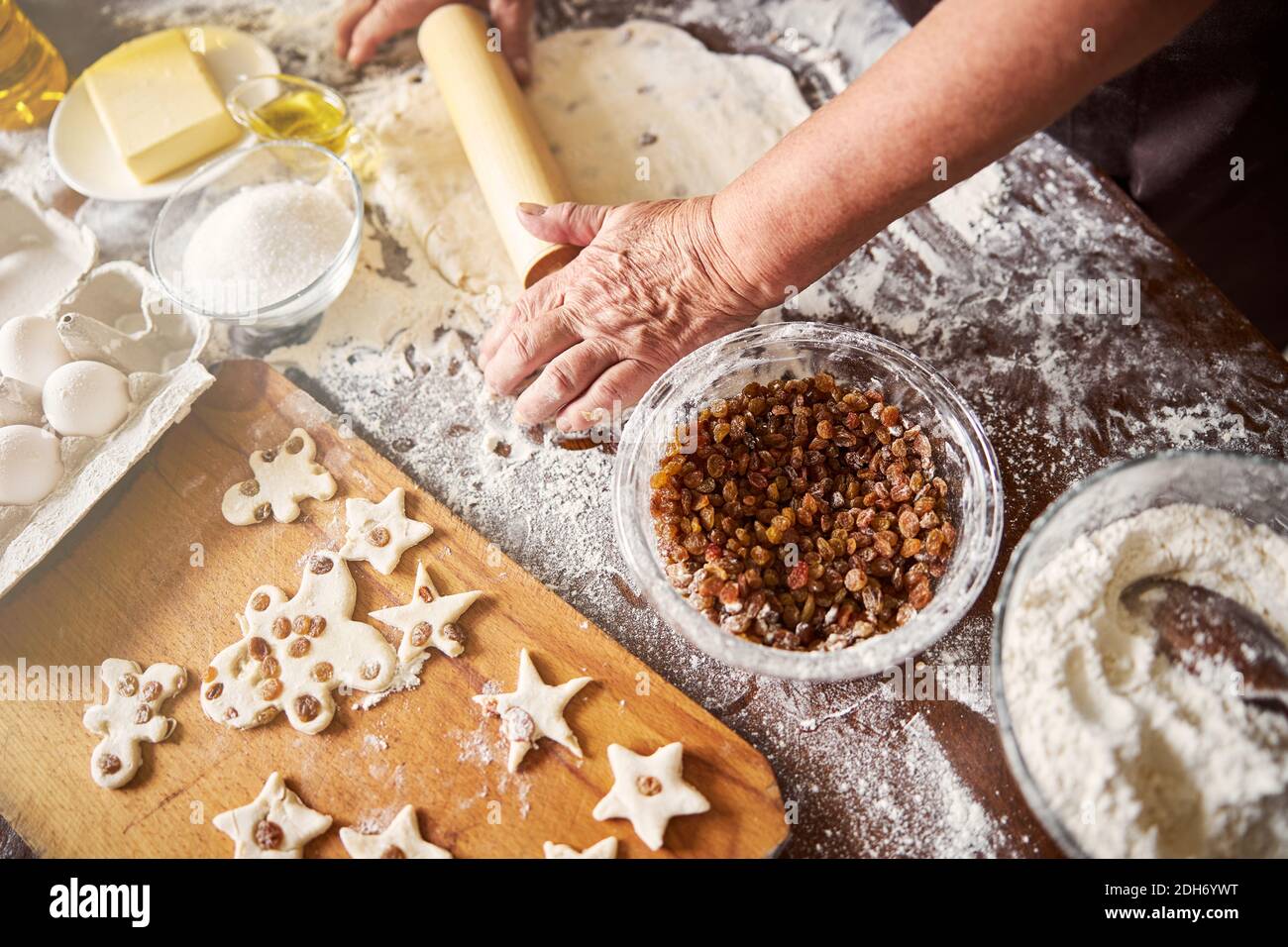 Skilled cook rolling out cookie dough in kitchen Stock Photo - Alamy