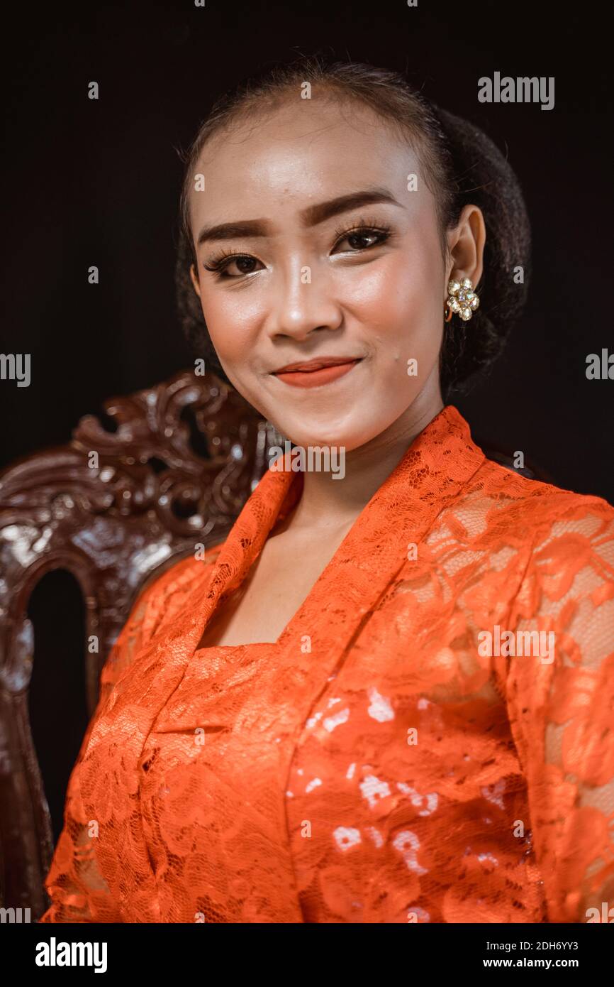 portrait of a young woman wearing Javanese kebaya traditional clothes ...