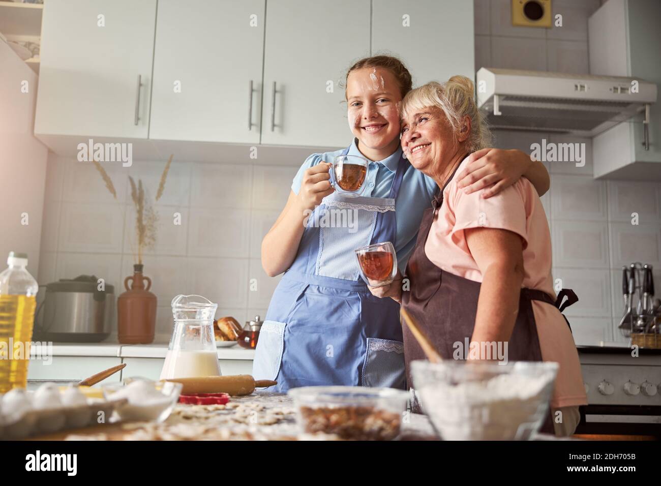 Happy elderle lady receiving hug from her granddaughter Stock Photo - Alamy