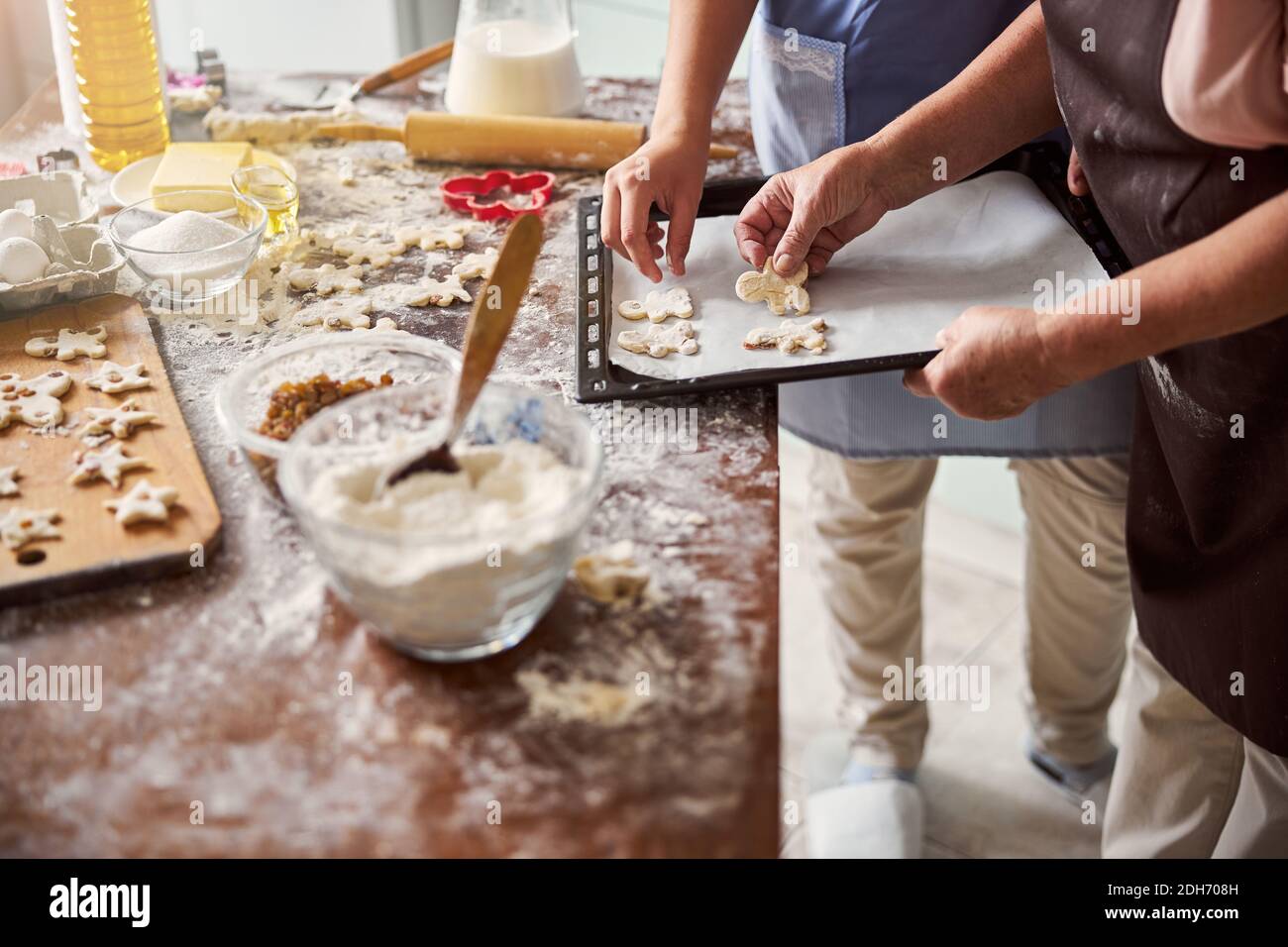 Lady and a girl preparing to bake some cookies Stock Photo - Alamy