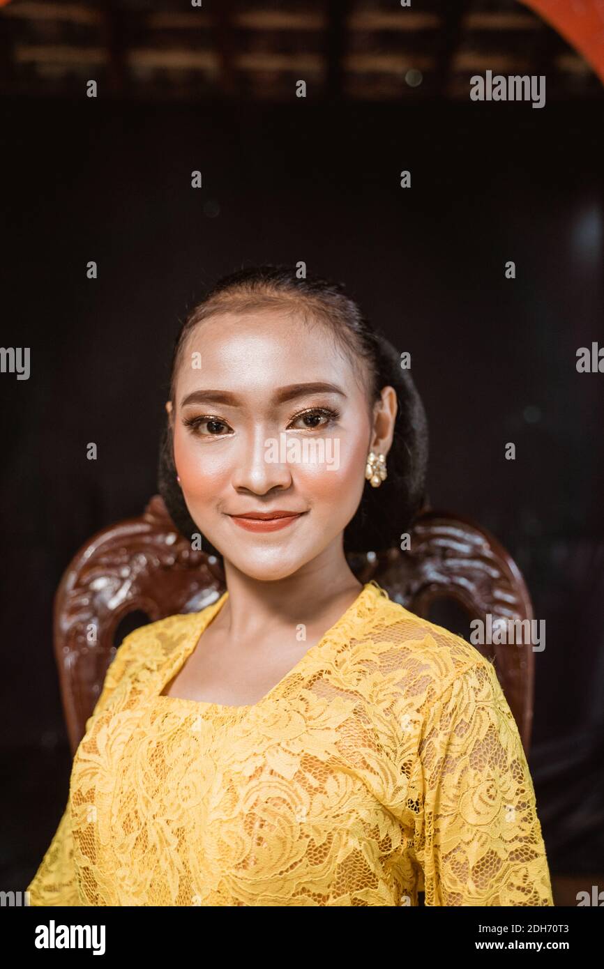 portrait of a young woman wearing Javanese kebaya traditional clothes ...