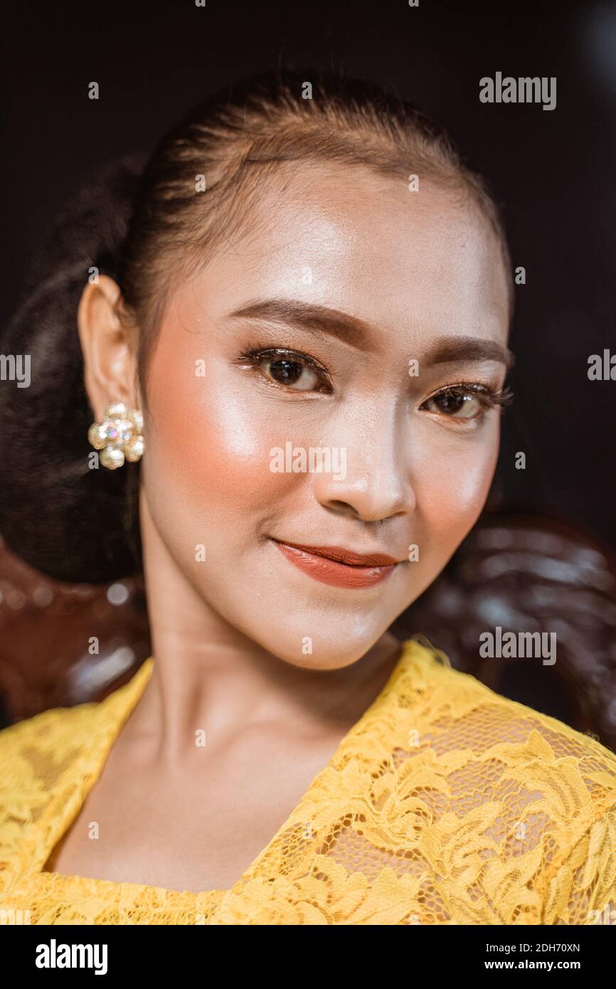portrait of a young woman wearing Javanese kebaya traditional clothes ...
