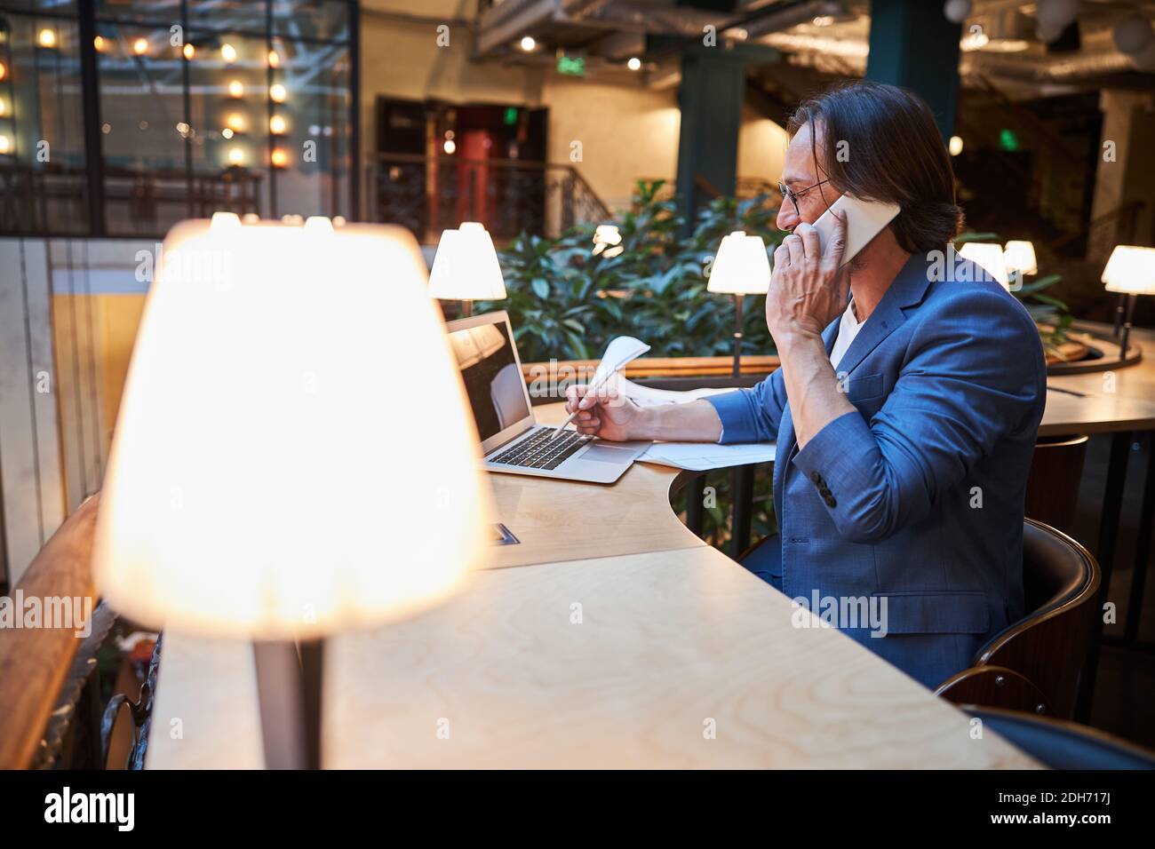 Focused employee working on a project and multitasking Stock Photo - Alamy