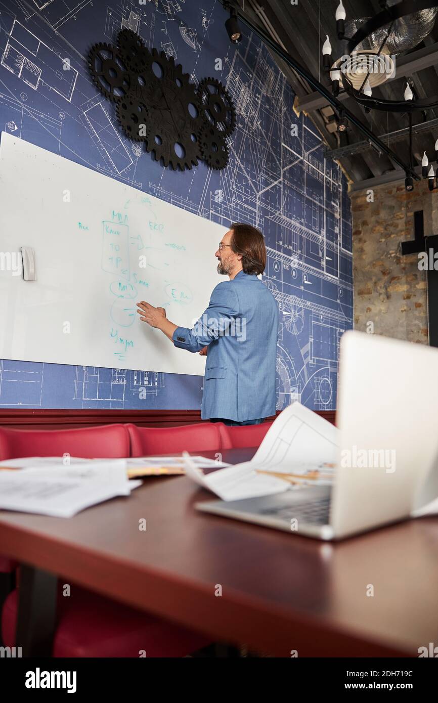 Enthusiastic professor presenting a project on a whiteboard Stock Photo ...