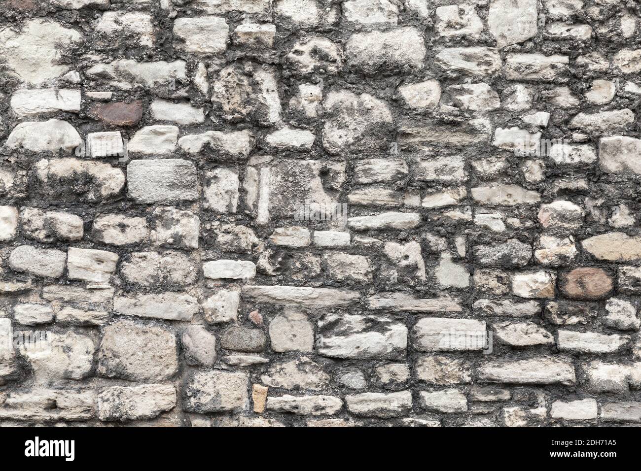 Old grungy dark gray stone wall, front view, background photo texture ...
