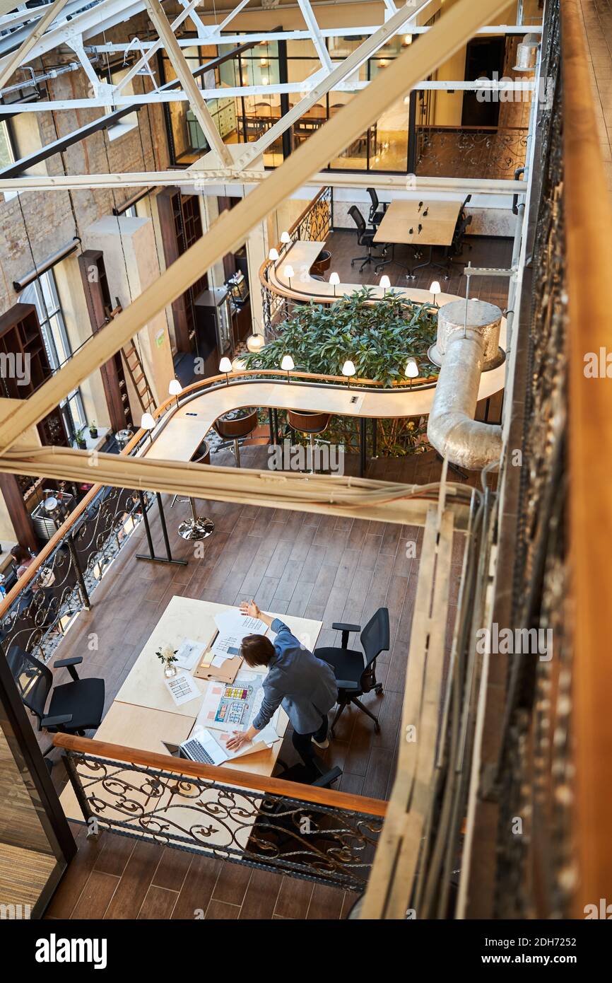 Busy man alone at an empty co-working space Stock Photo - Alamy