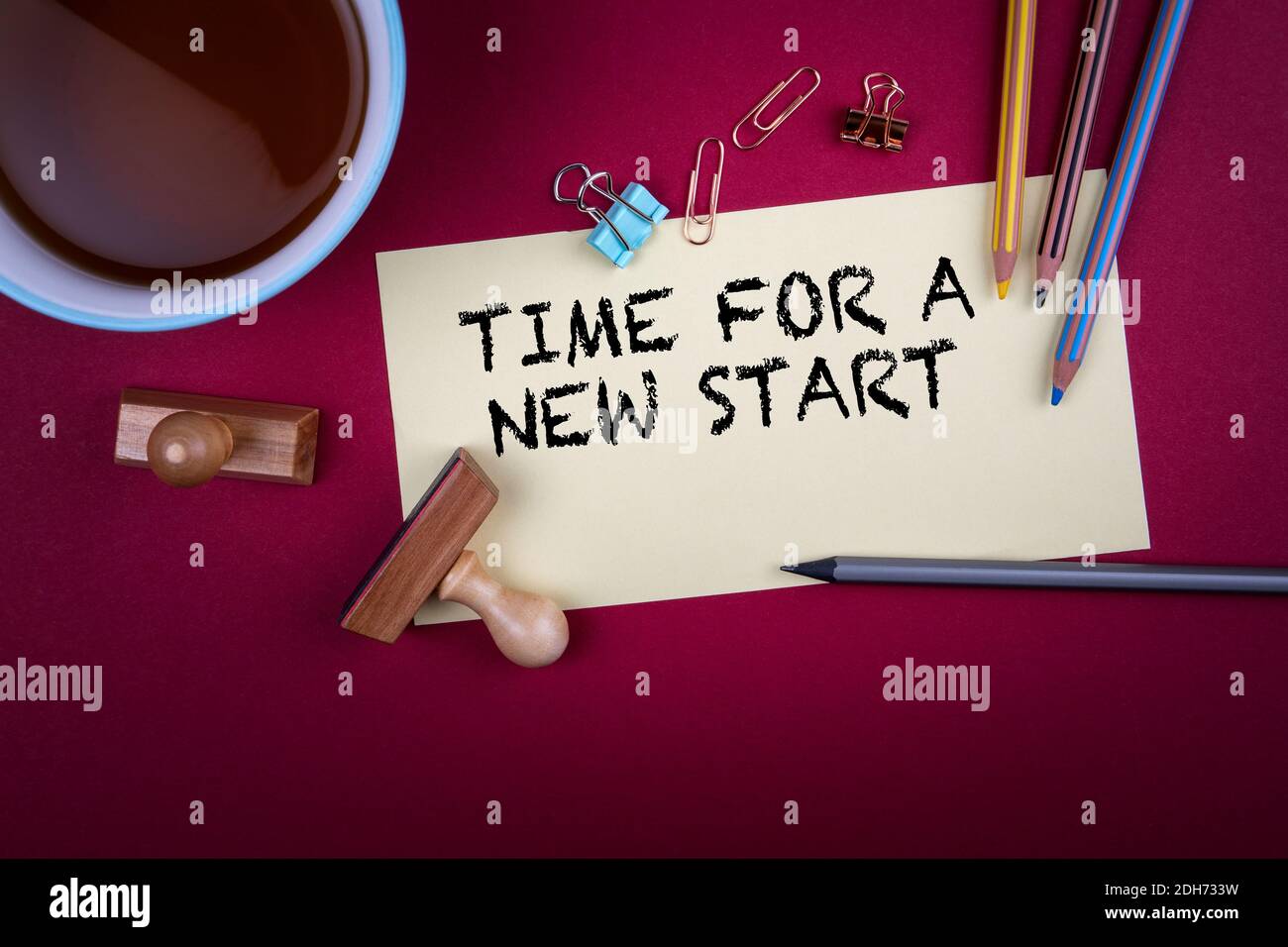 Time For A New Start. Tea cup and colored pencils on a red table Stock ...