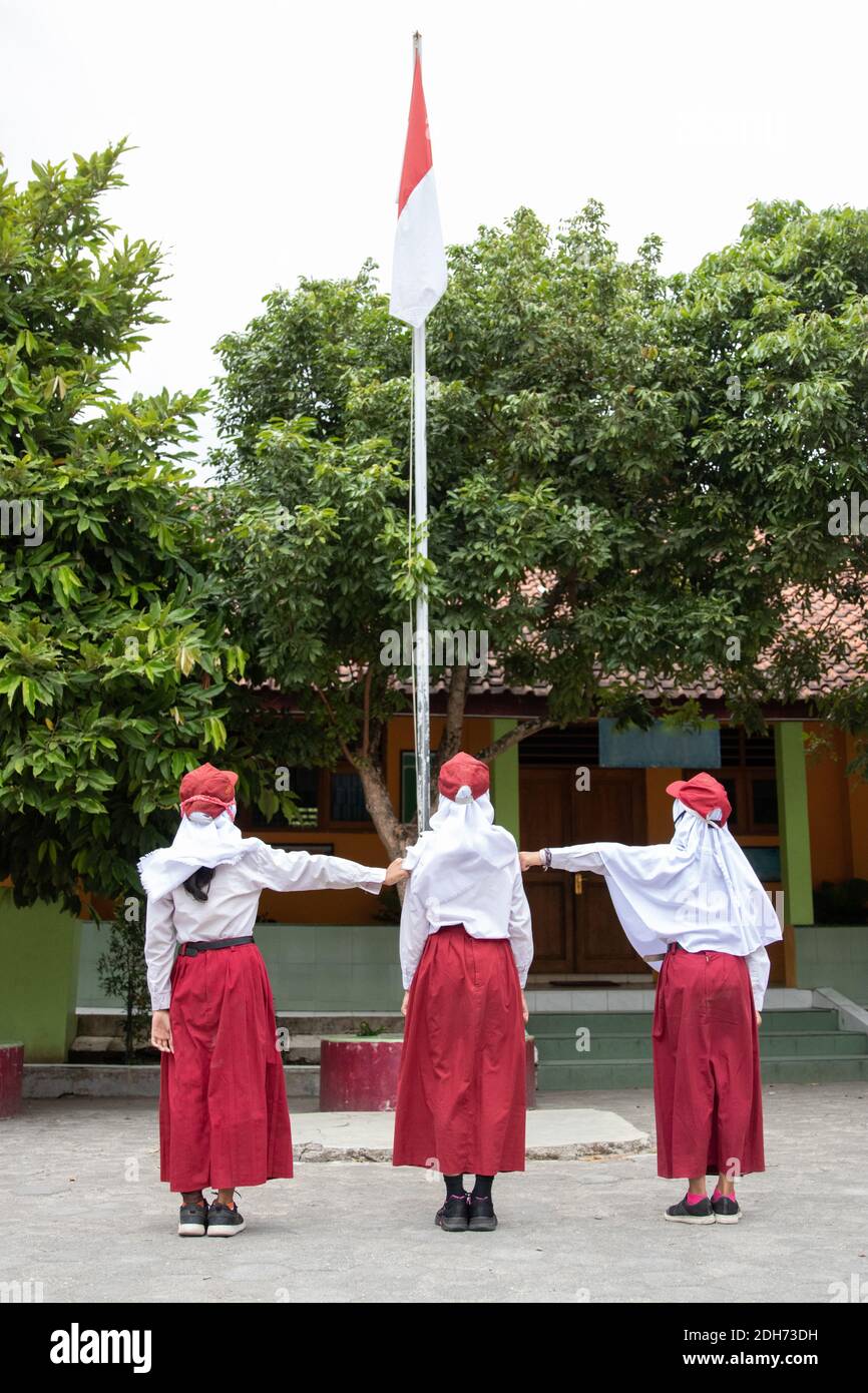 a portrait of indonesian elementary school flag raiser aranging the ...