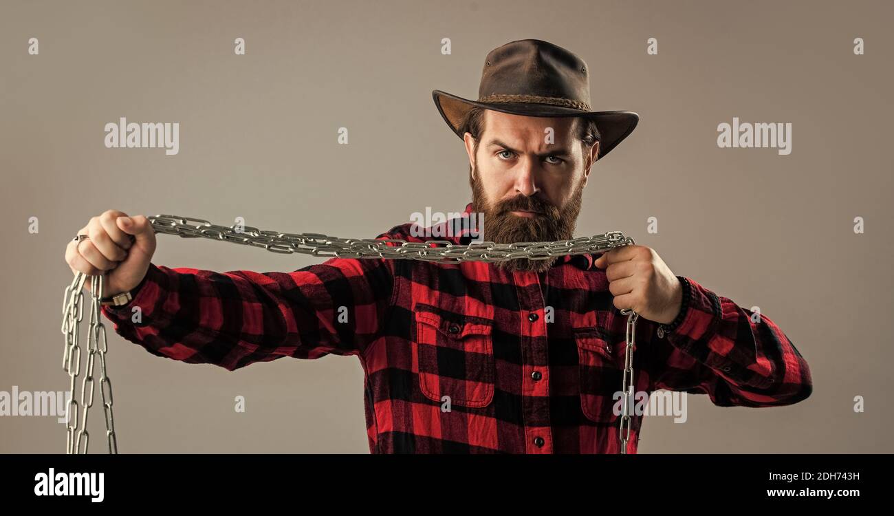 caucasian man with powerful metal chain in hands. handsome man with ...