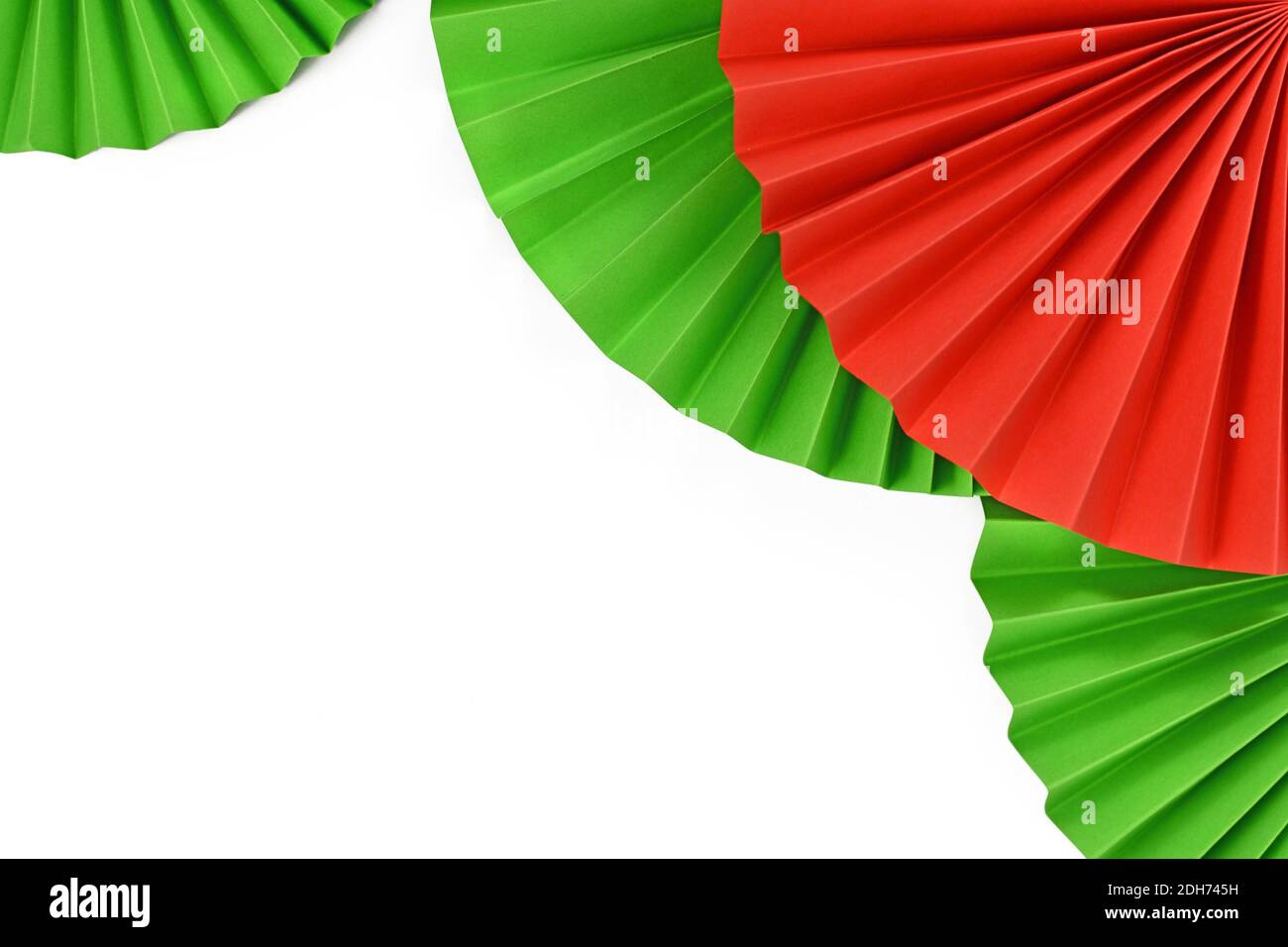 Red and green paper craft rosettes in traditional Christmas colors on ...