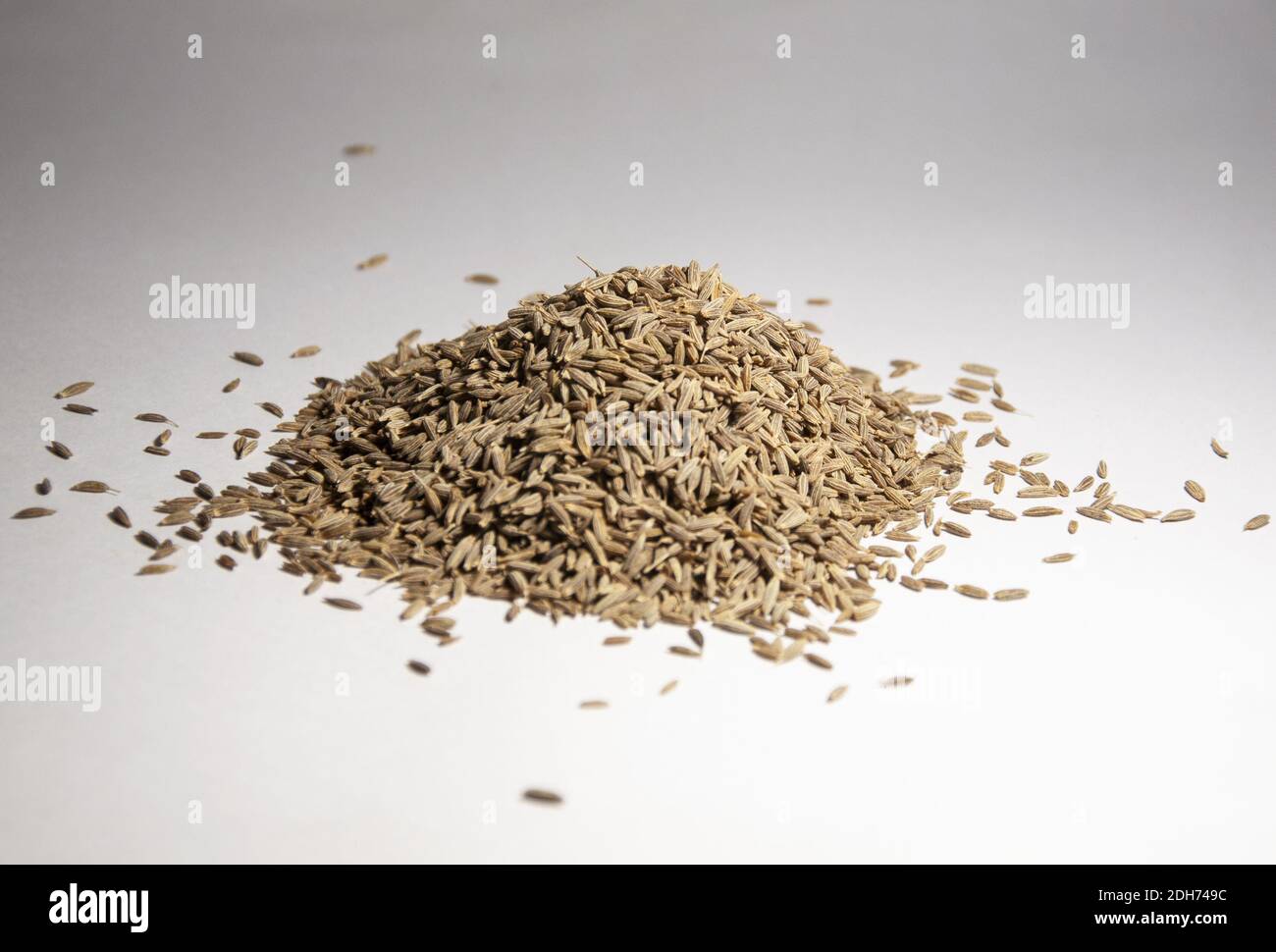 A closeup picture of cumin seeds on a white isolated background with ...