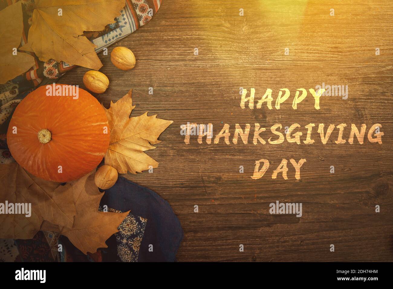 A top view shot of pumpkins, autumn leaves and "Happy Thanksgiving Day ...