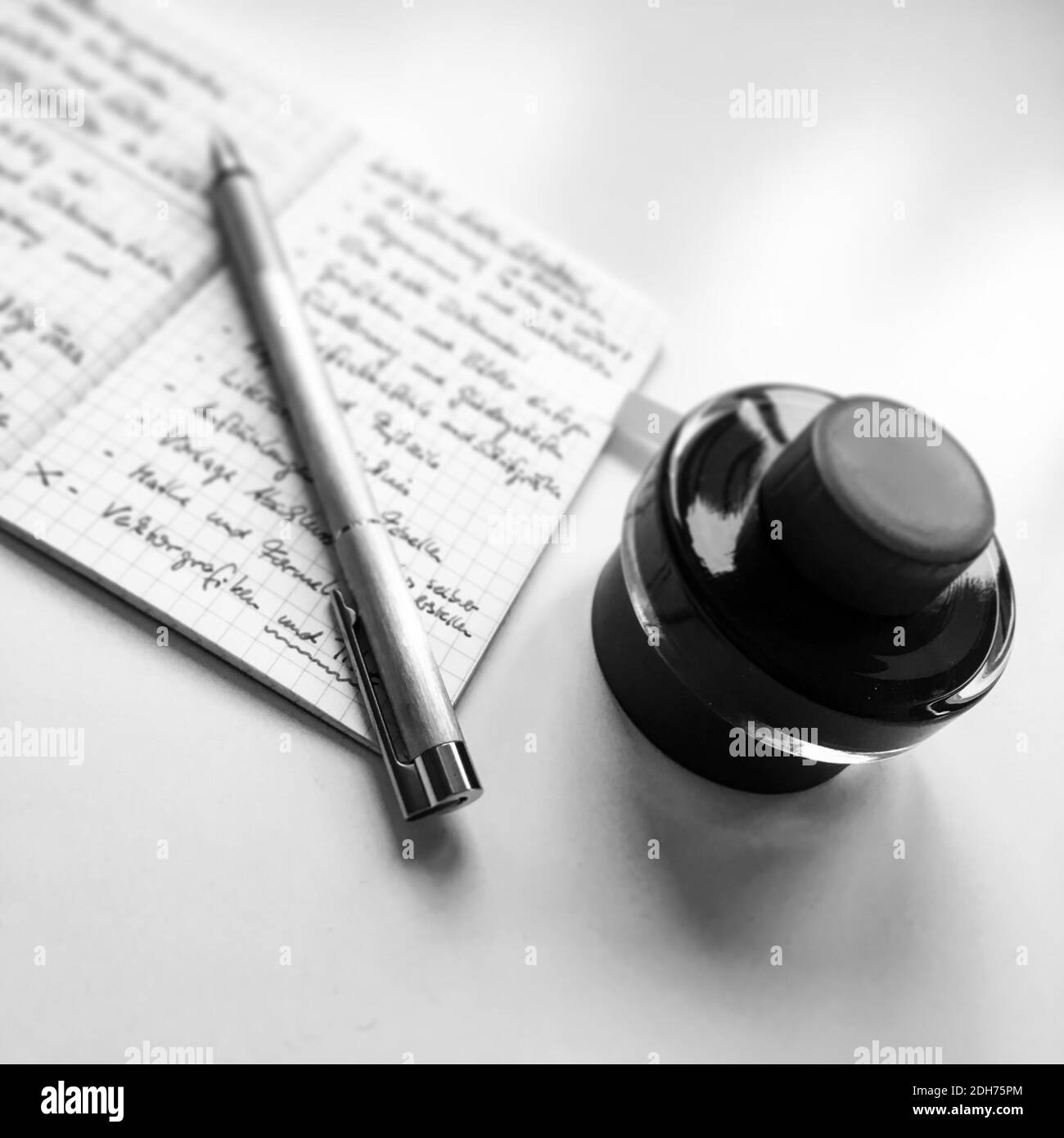 A selective focus shot of a notebook with an open written page with a ...