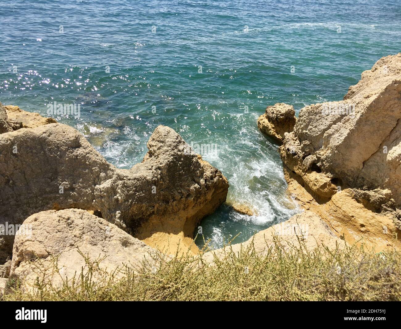 A beautiful view of the light multicolor ocean from the cliff with the ...