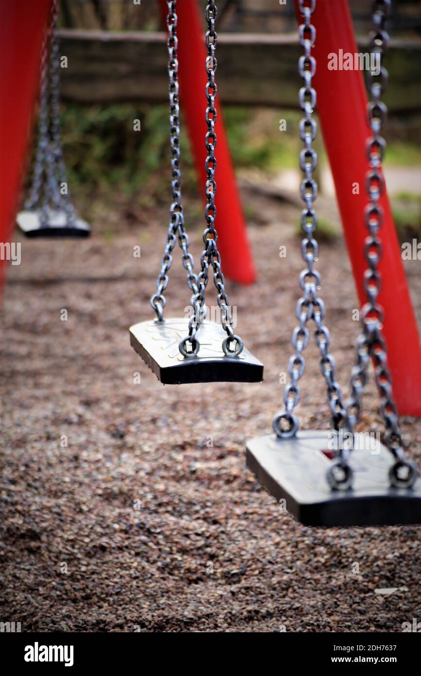 Empty swings playground in park hi-res stock photography and images - Alamy