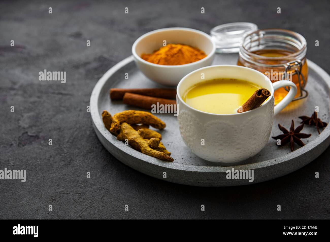 Yellow turmeric latte drink. Golden milk with cinnamon, turmeric ...