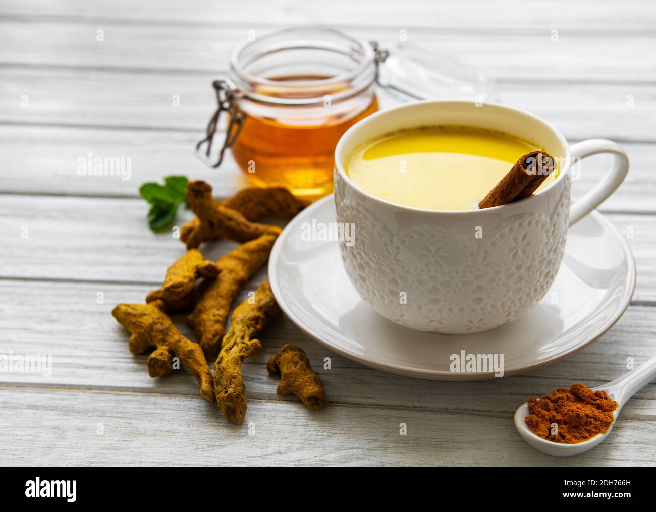 Yellow turmeric latte drink. Golden milk with cinnamon, turmeric ...
