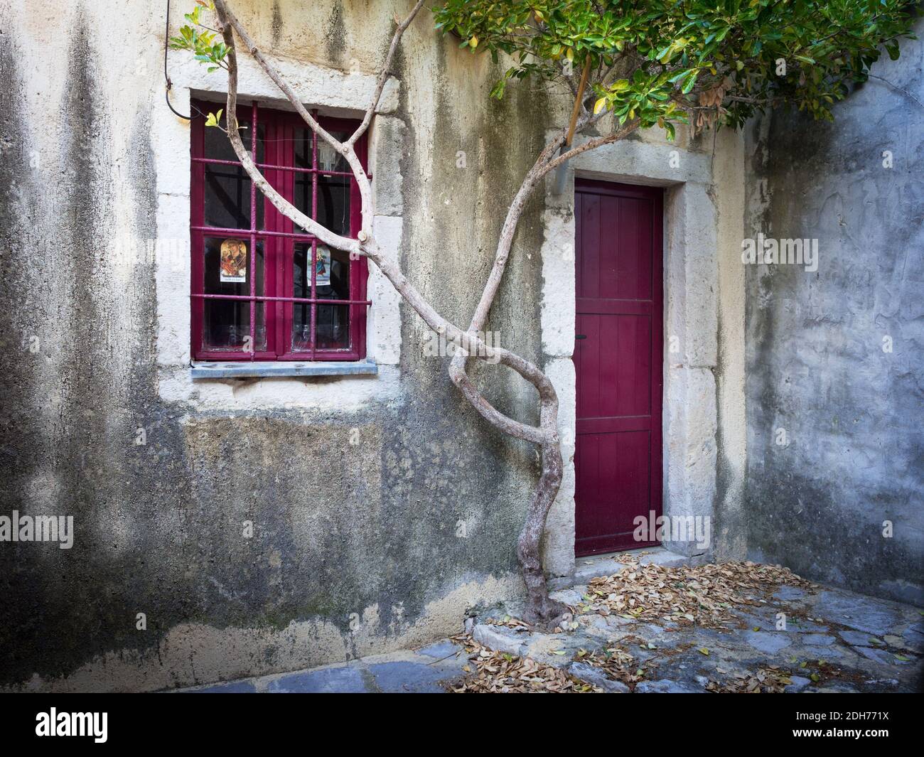 Red door and window at an old house in the town of Rab Croatia Stock ...