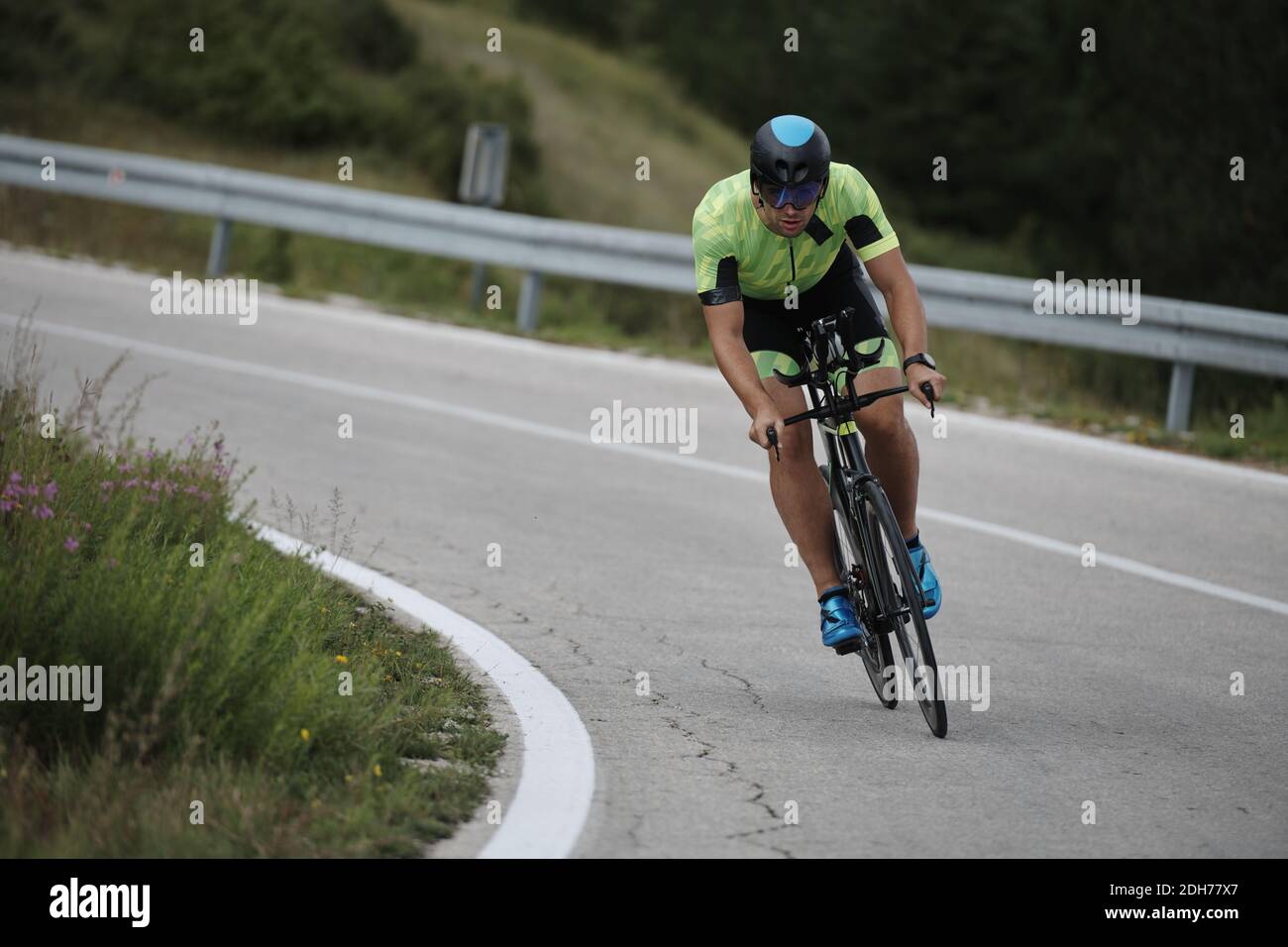 Triathlon athlete riding bike Stock Photo - Alamy