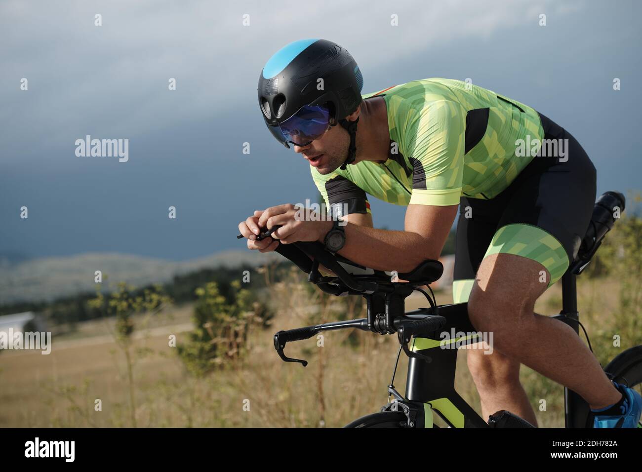 Triathlon athlete riding bike Stock Photo - Alamy