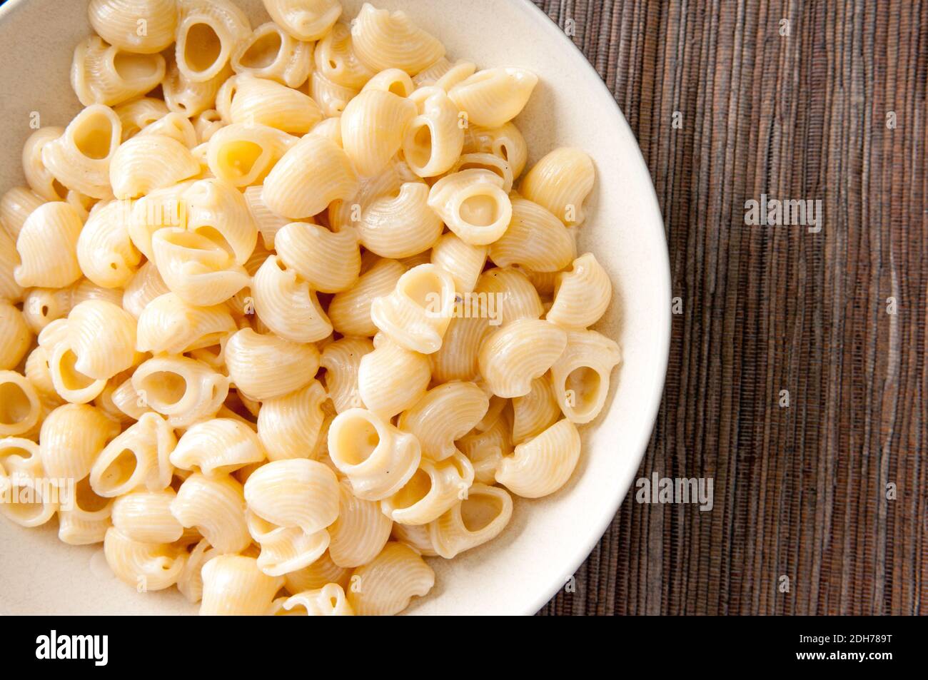 Pipe or shell pasta with a creamy alfredo sauce and parmesan cheese ...