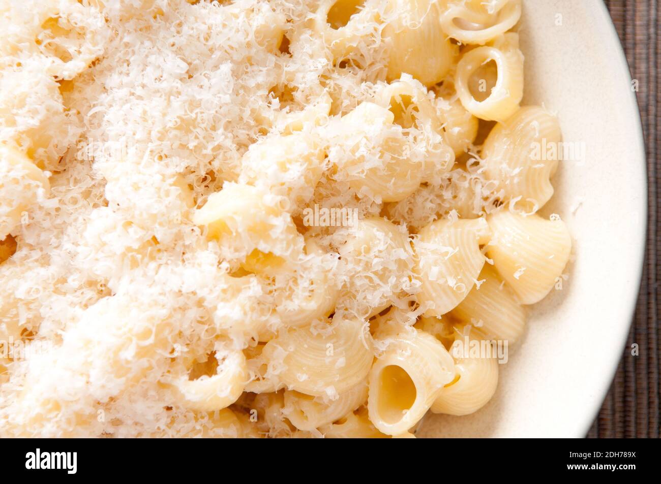 Pipe or shell pasta with a creamy alfredo sauce and parmesan cheese ...