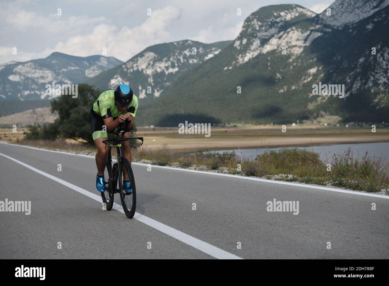 Triathlon athlete riding bike Stock Photo - Alamy