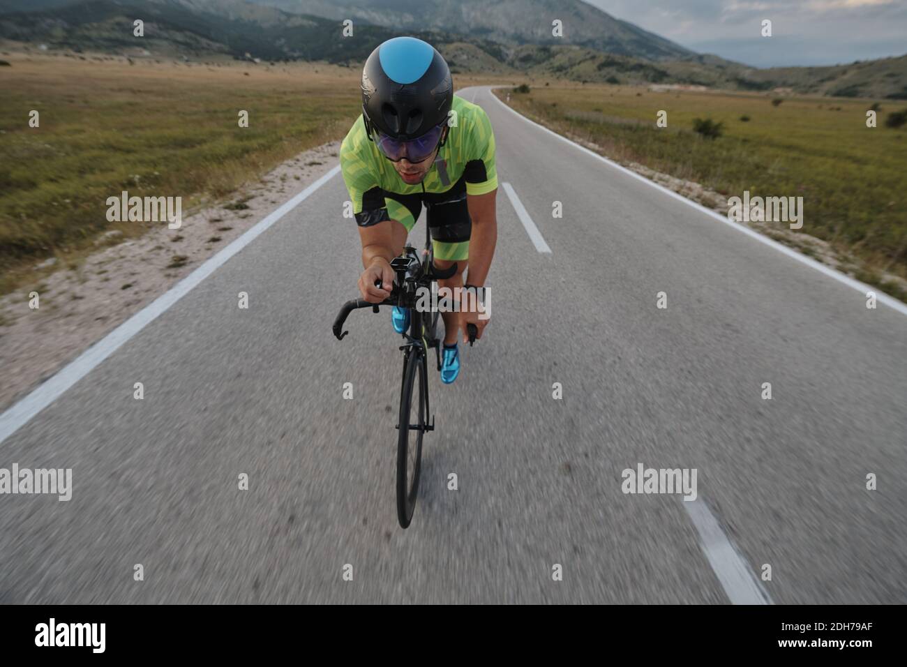 Triathlon athlete riding bike Stock Photo - Alamy