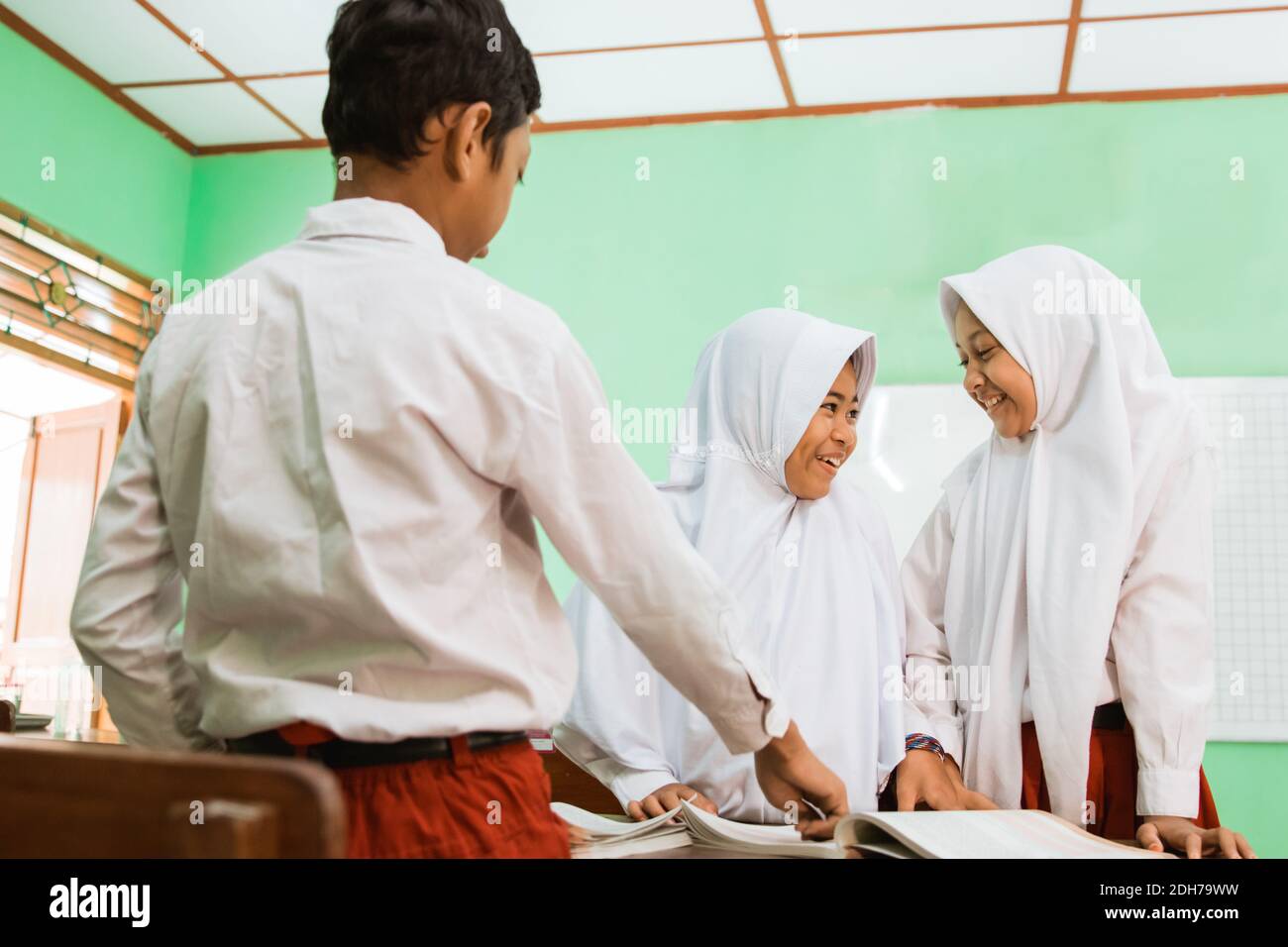 portraits of islamic school students have a discussion in the class ...