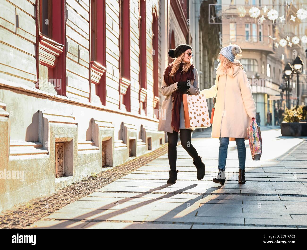 A shot of happy girls walking on the street after shopping Stock Photo ...
