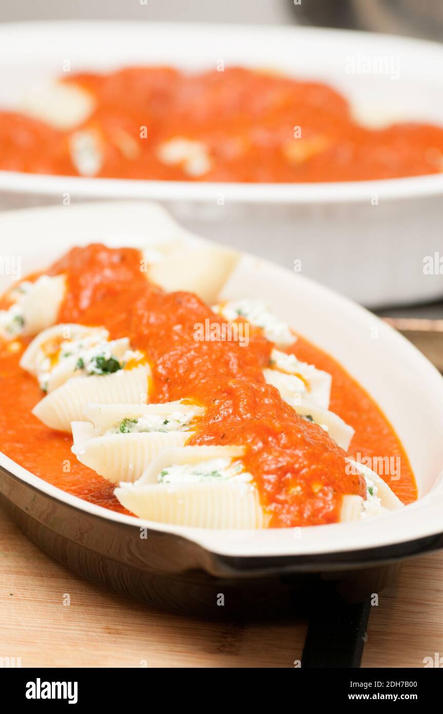 uncooked hand stuffed conchiglie pasta with goat cheese and spinach and ...
